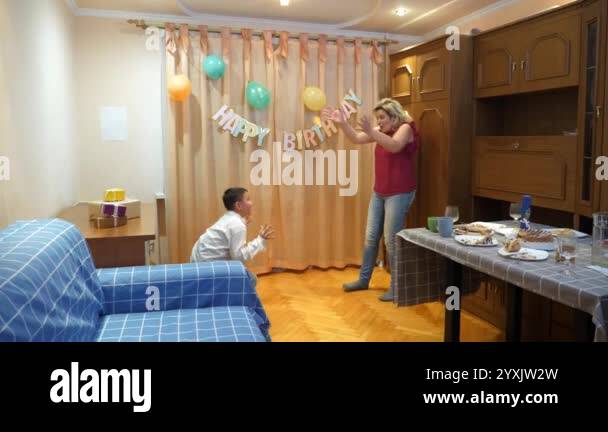 Celebrating a child's birthday, people dance, play and have fun ...