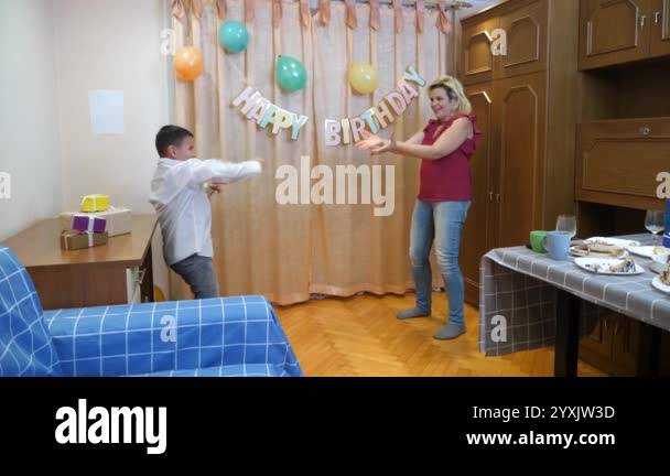 Celebrating a child's birthday, people dance, play and have fun ...