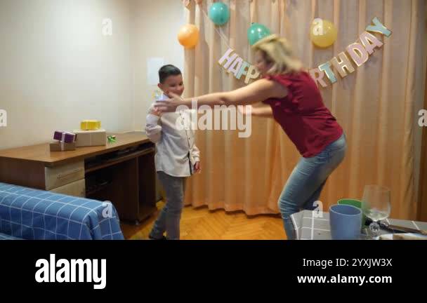 Celebrating a child's birthday, people dance, play and have fun ...