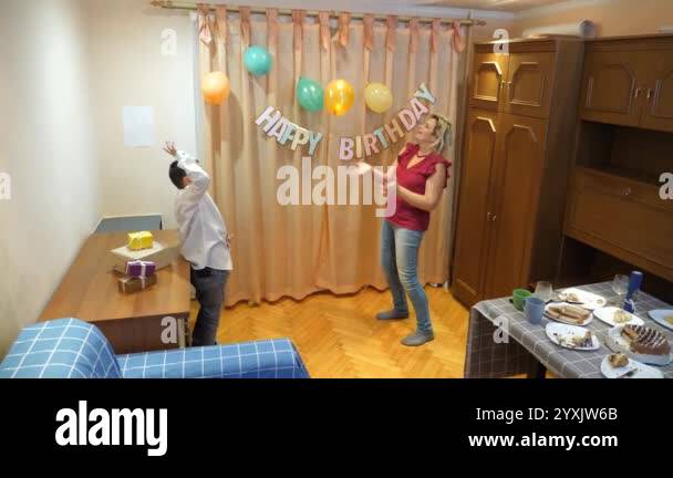 Celebrating a child's birthday, people dance, play and have fun ...