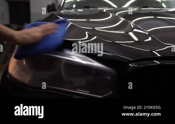 Cleaner worker dry body car after washing automobile 4k video. Hand car ...