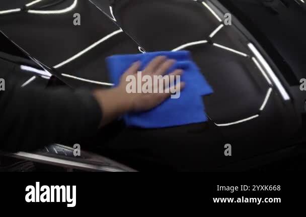 Hand car drying with microfiber and detergent in detailing auto service ...