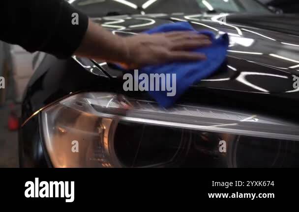 Cleaner worker dry body car after washing automobile 4k video. Hand car ...