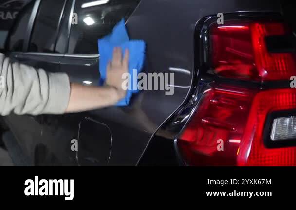 Hand car drying with microfiber and detergent in detailing auto service ...