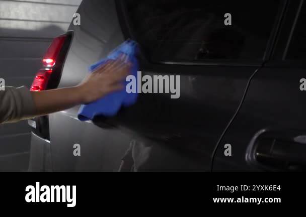 Car detailing - polishing car using microfiber cloth 4k video. Wiping a ...