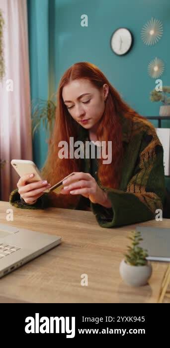 Happy woman using bank credit card and smartphone for online shopping ...