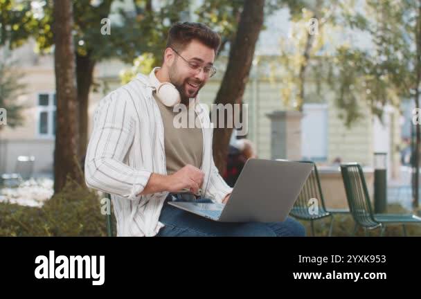 Sad young man tourist using laptop computer typing browsing, loses ...