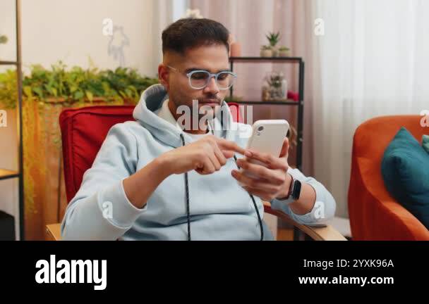 Sad displeased Arabian man use smartphone typing browsing, loses ...