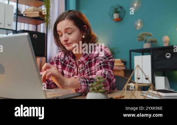 Bored sleepy young businesswoman worker working on laptop computer ...