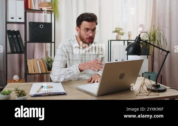 Nervous angry Indian manager quarrelling laptop call online at home ...