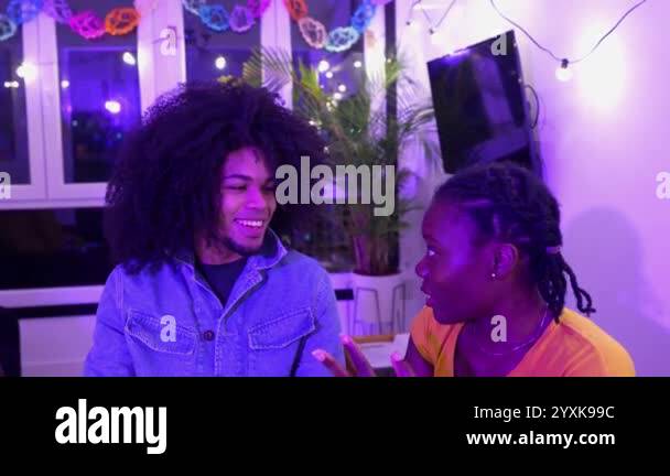 Lively discussion unfolds among a multi ethnic group of friends during ...