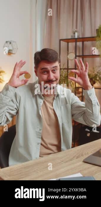 Young man freelancer stock trader earning holding showing bitcoins BTC ...