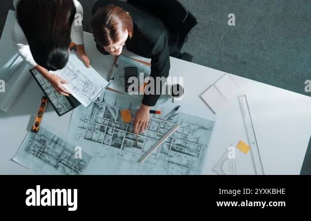 Top view of businesswoman hand blueprint to engineer sitting at meeting ...