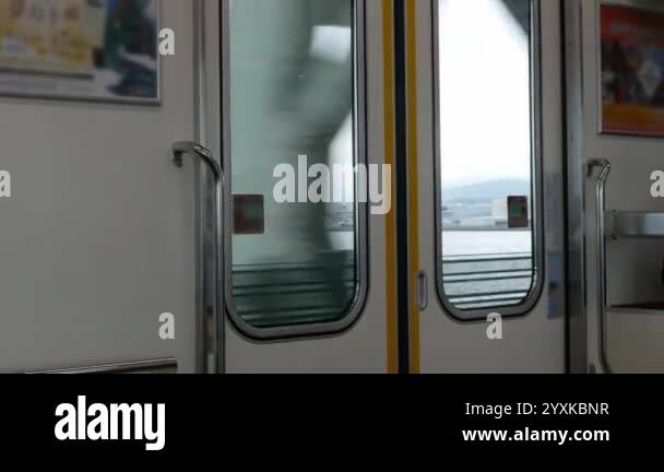 view from inside train commuter through train door's window while ...
