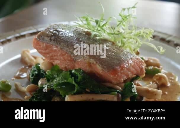 close up to a plate of fresh grilled salmon steak with fired mushroom ...
