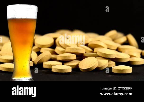 brewers yeast tablets on a turn table with a glass of German wheat beer ...