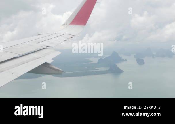 view through airplane aircraft window with wing view while approaching ...