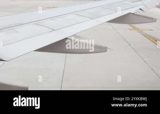 view to rear wing of airplane while aircraft pushback from gate ...