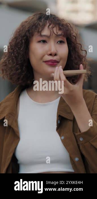 Modern Woman Recording Voice Message On Phone While Standing In City ...
