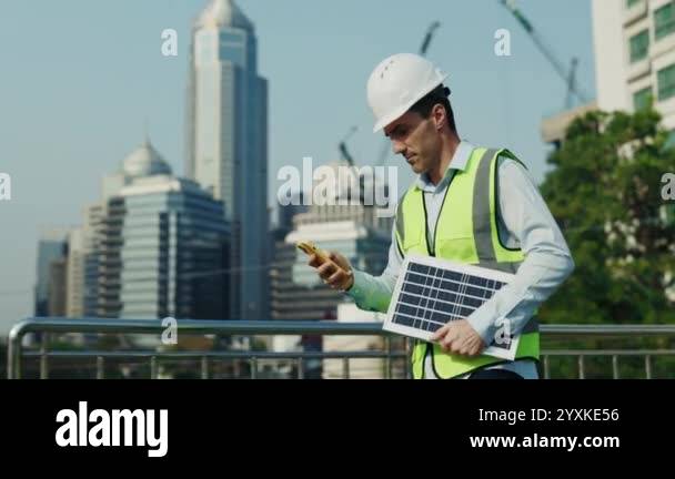 Man engineer reads message on phone walking along pedestrian bridge ...