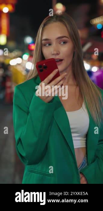 Portrait of positive young woman talking on smartphone with hands free ...