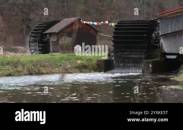 Wooden Mill Wheel Spinning in Slow Motion, Splashing Water Streams on a ...
