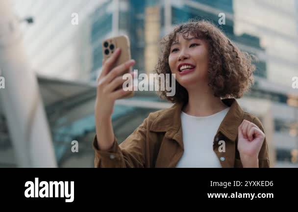 Positive Curly-Haired Beautiful Girl Standing Outside Speaking Aloud On ...