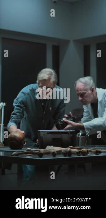 Two archaeologists take picture of fossil remains of prehistoric human ...