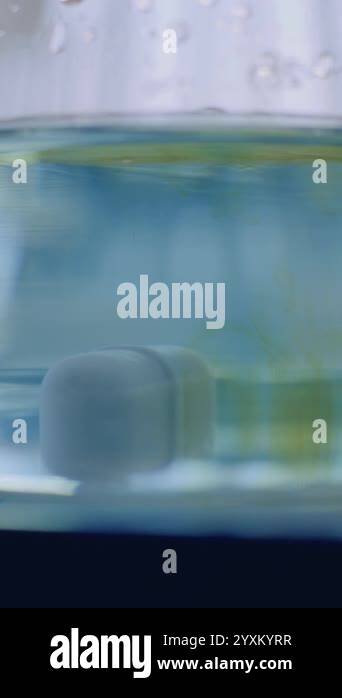 Vertical shot Scientist, chemist pours liquid in glass flask. Close up ...