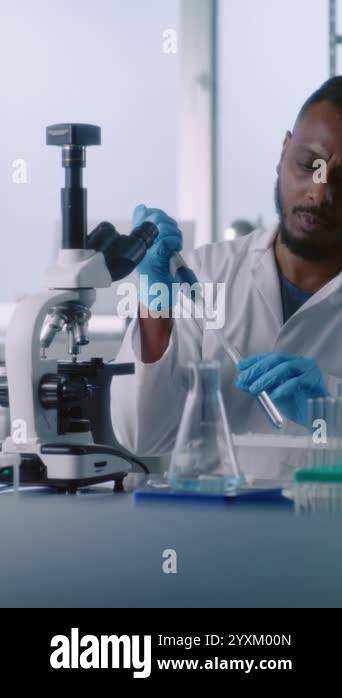Medical science lab: African American microbiologist takes liquid from ...