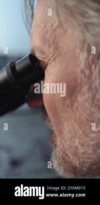 Vertical shot of mature microbiologist or chemist analyzing fossil ...