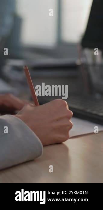 Vertical shot Close up of female employee taking notes, writing down ...