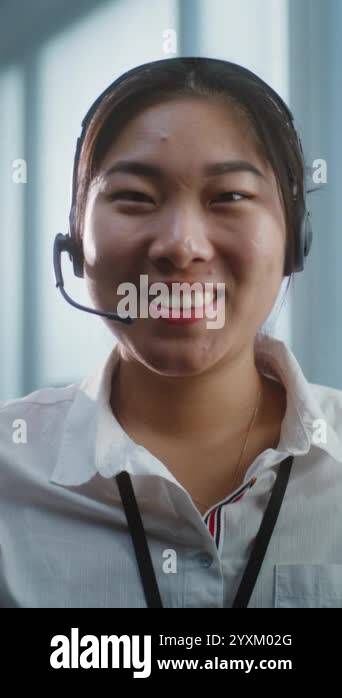 Call center office: Close up portrait of friendly Asian female technical customer support ...