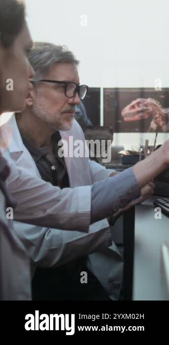 Male and female scientists discuss three dimensional model of ancient ...