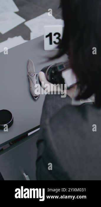 Robbery or murder case: Vertical shot of female criminalist taking ...