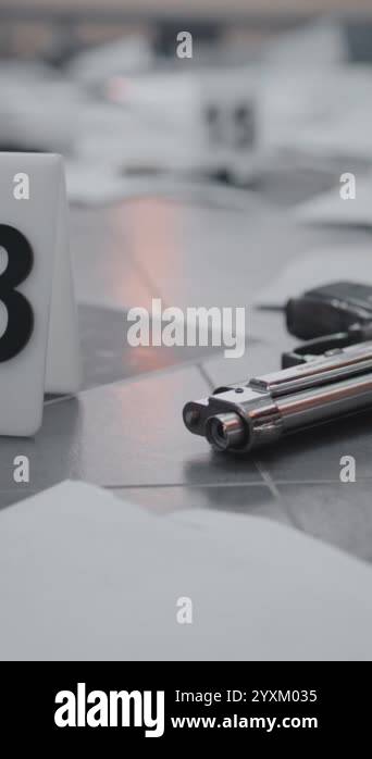 Vertical shot of murder weapon lying next to numbered marker at crime ...