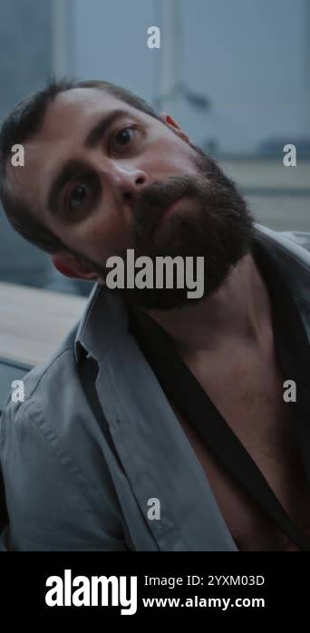 Frustrated office worker sits on the floor in destroyed office room ...