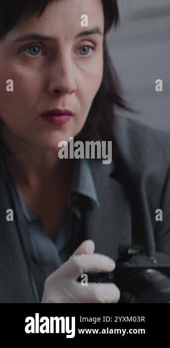 Office robbery or murder case: Vertical shot female forensic scientist ...