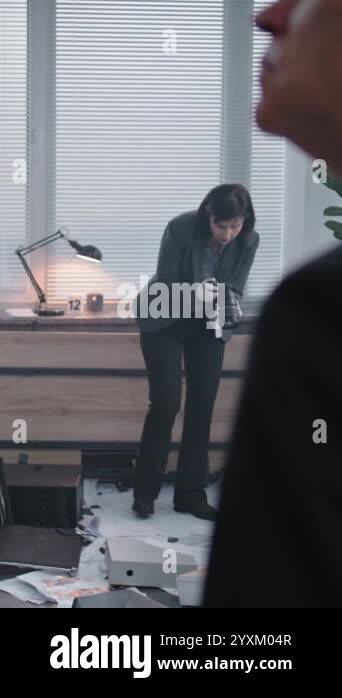 Vertical shot Crime investigation team working. Male detective examines ...