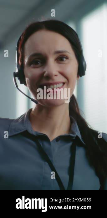 Call center office: Vertical shot of friendly Caucasian female helpdesk specialist in headset ...