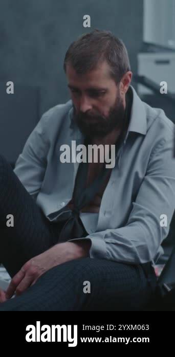 Frustrated office worker sits on the floor, breathes heavily after ...