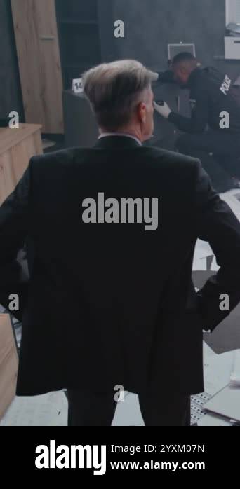 Office robbery case: High angle of detective examining crime scene ...