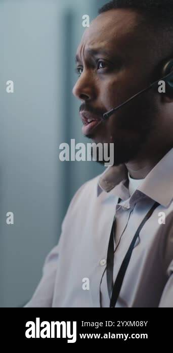 Psychological hotline call center: Vertical shot of African American ...
