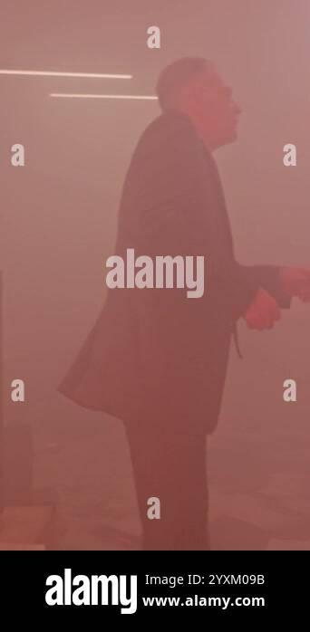 Vertical shot of diverse people in panic and fear running around the ...