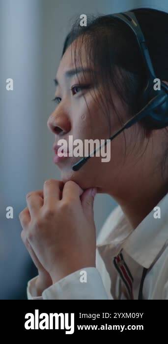 Modern call center office of mental health line: Vertical shot of Asian ...