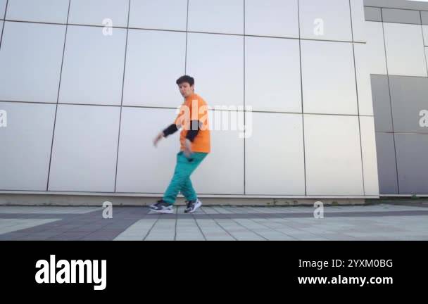 young energetic guy dancer breakdancing outdoors in the city on the ...