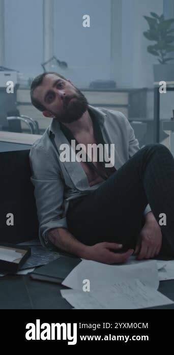 Depressed businessman sits on the floor after fit of rage over failed ...