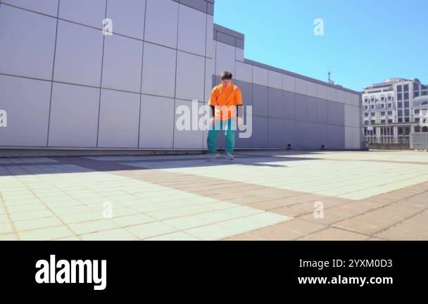 young energetic guy dancer breakdancing outdoors in the city on the ...