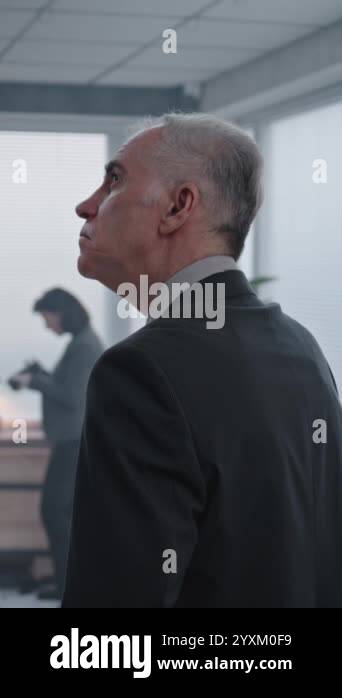 Office robbery case: Vertical shot of male detective examining crime ...
