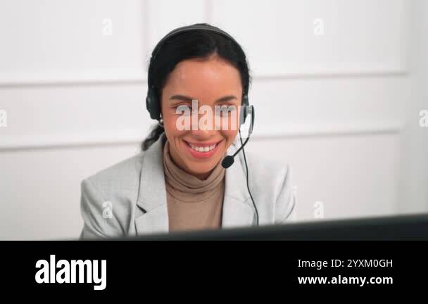 Businesswoman wearing headset working in office to support remote ...